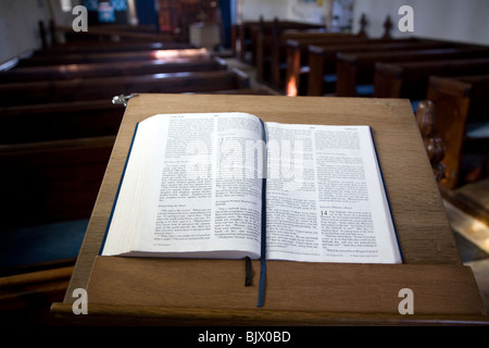The Holy Bible on a lectern open at the book of Revelation in front ...