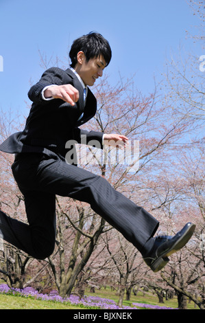 Young Japanese businessman jumping Stock Photo - Alamy
