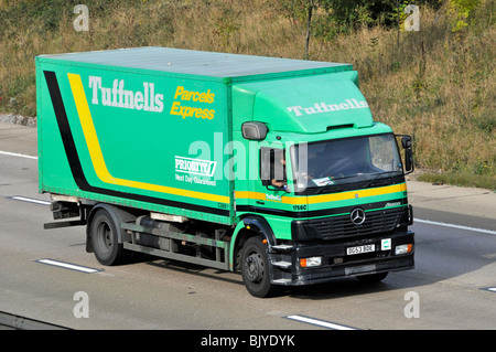 Side view of Tuffnells Parcel Express business hgv lorry truck towing ...