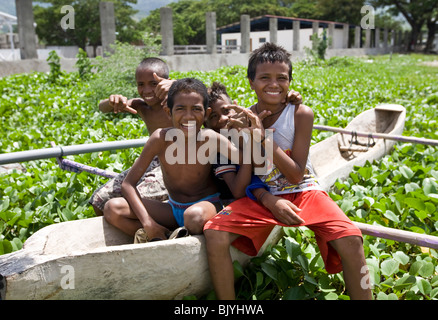 boys in dug-out canoe Stock Photo - Alamy