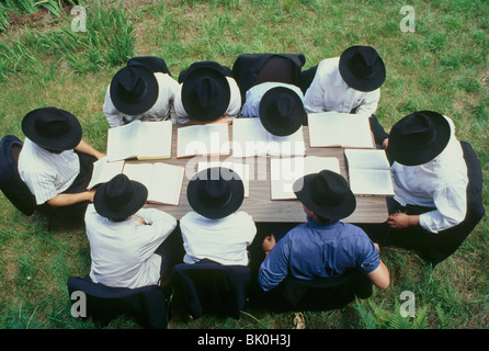 A group of religious Jewish boys studying together at a synagogue in ...