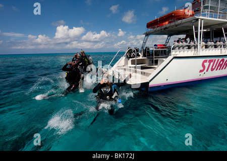 Scuba divers enter water from boat via giant stride entry Stock Photo ...