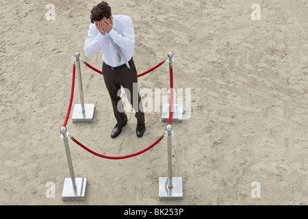Business people standing in roped-off area Stock Photo - Alamy