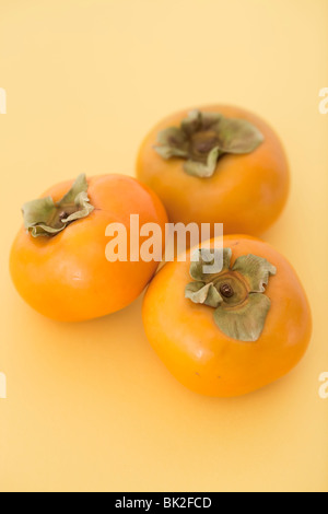 Fruit juice. Persimmon Juice (Diospyros kaki L.)> Aged wood background ...