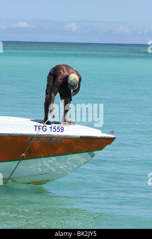 Man on motor boat tobago Stock Photo - Alamy