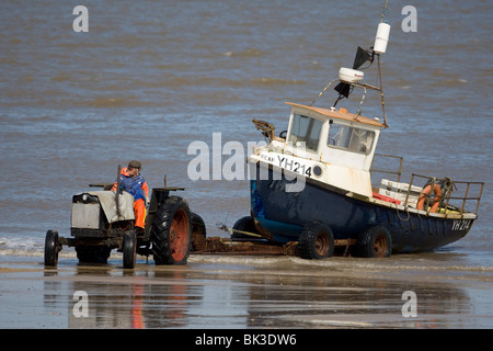 Crab boat tractors and trailers on Cromer beach while the boats are at ...