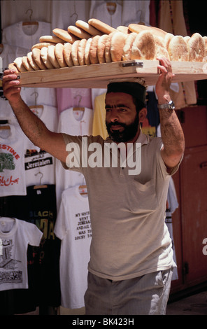 Israel, Jerusalem. Man carrying bread in the Arab quarter market Old ...