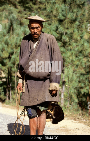 Bhutanese man with a traditional bamboo hat, Trongsa District, Trongsa ...