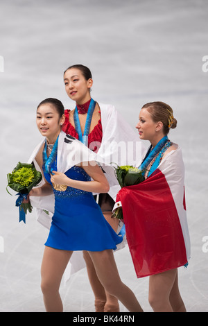Kim Yu-Na (KOR), Mao Asada (JPN) and Joannie Rochette (CAN) wrapped in ...
