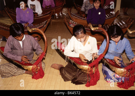 Burmese man playing the Saung Gauk, Burmese harp or arched harp ...