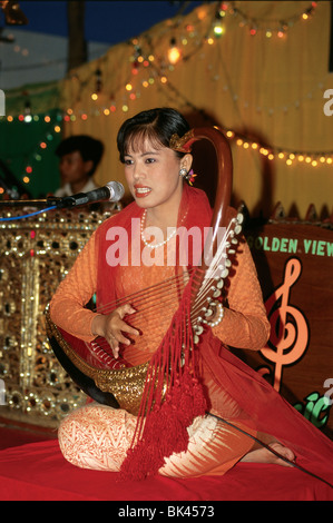 Musician playing a saung, traditional Burmese arched harp, Yangon ...
