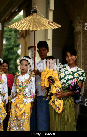 Boys in silk garments preparing for a traditional Buddhist monk ...