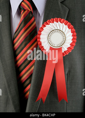 Blank Blue Rosette pinned to jacket Stock Photo - Alamy