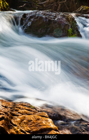 waterfall and stream with strong current of water Stock Photo - Alamy