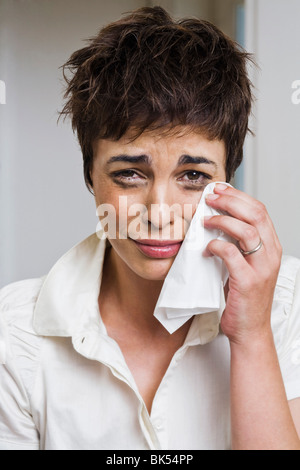 Waist-up shot of unhappy miserable and sad cute blonde female in white ...