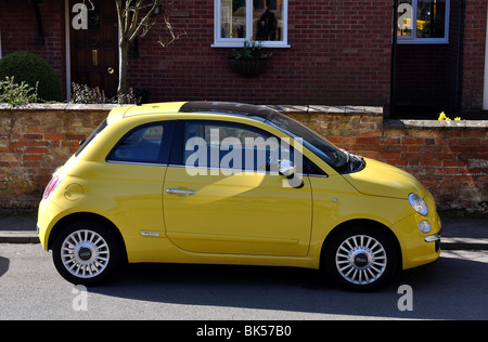 Bright yellow colour Fiat 500 Cinquecento- typical Italian small city ...