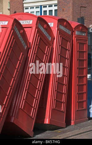 Red telephone box in Kingston London. Series of phone boxes leaning on ...