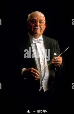 Orchestra conductor in black tuxedo in dark studio Stock Photo - Alamy