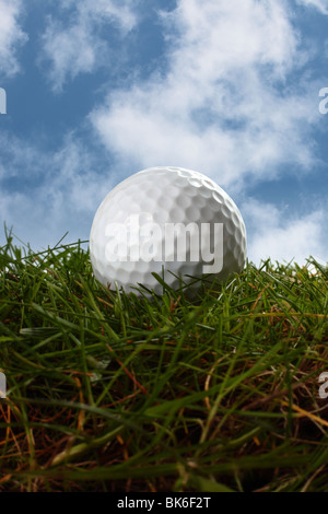 Golf ball on blue background Stock Photo - Alamy