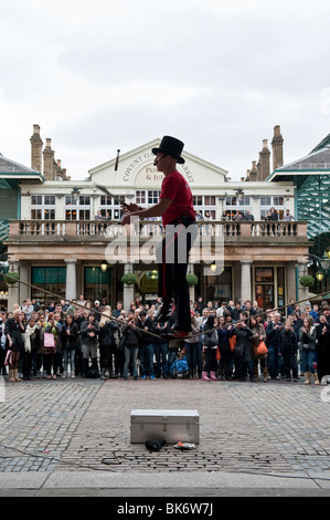 A knife juggler performs in the market of Covent Garden of London ...