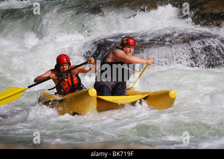 TWO MEN IN PONTOON RAFT BOAT SPLASHING THROUGH RAPIDS BULL SLUICE ...