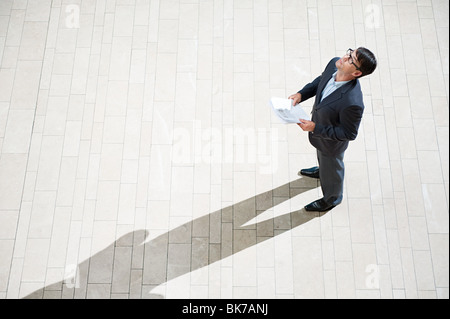 Businessman looking up Stock Photo - Alamy