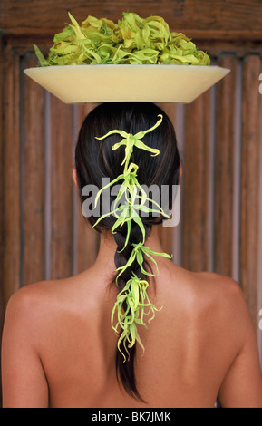 Woman with long hair back view on blue background Stock Photo - Alamy