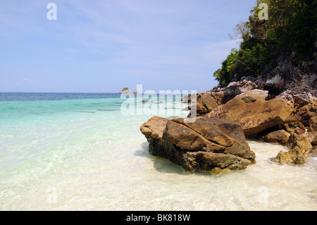 Rocks on sandy beach with tropical vegetation, Tonga Quarry, Tonga Bay ...