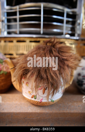 Frankie Howard's wig displayed on a teapot in the living room of ...