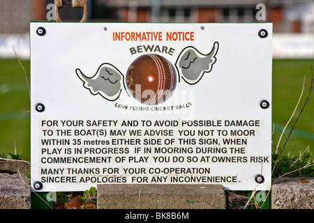 Beware of flying cricket balls sign Stock Photo - Alamy