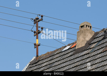 Old domestic overhead power lines with ceramic insulators on roof Stock ...