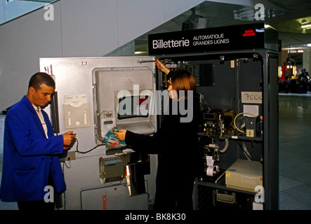 Technician repairing broken ticket machine inside station on the ...