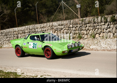 Green 1974 Lancia Stratos sports car racing in the Classic car rally ...