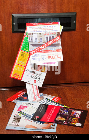 Leaflets through letterbox Stock Photo - Alamy
