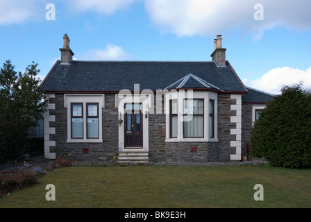 Exterior of stone cottage with bay trees in planters on either side of ...
