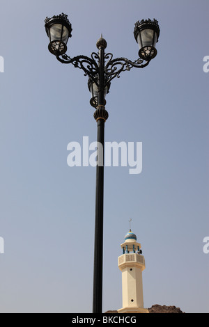 Sultan Qaboos Street, mosque, minaret, houses, palm trees, green, cars ...