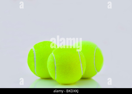 three tennis balls in a triangle formation on a white back ground Stock ...