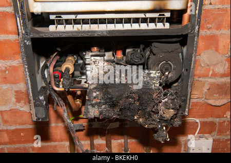 Burnt out domestic boiler and control panel following fire caused by ...