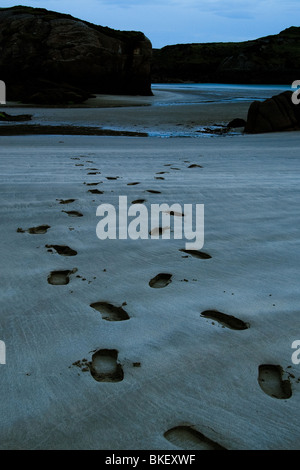 Footsteps at night on beach Stock Photo - Alamy