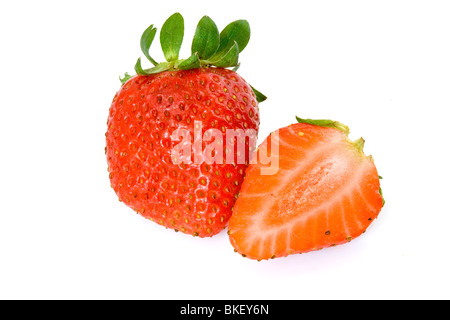 Close up of one cut strawberry on a pile of fresh ripe strawberries ...