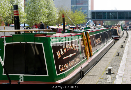 Traditional narrowboat with bright red and green livery painted on ...