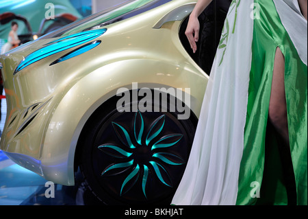 A model poses beside an IAT "Zu" electric concept car, designed by IAT ...
