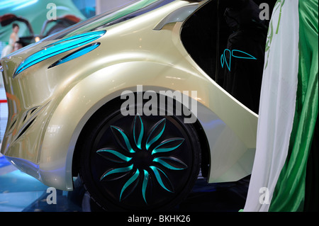 A model poses beside an IAT "Zu" electric concept car, designed by IAT ...
