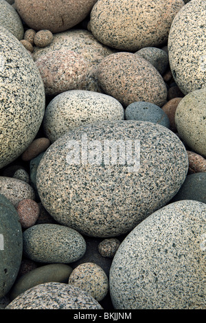 A photograph of smooth round granite rocks on a beach Stock Photo - Alamy