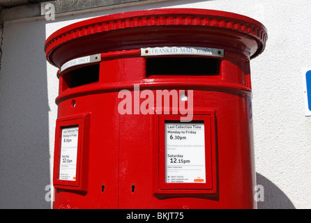 Close up of red franked mail letter box letterbox postbox England UK ...