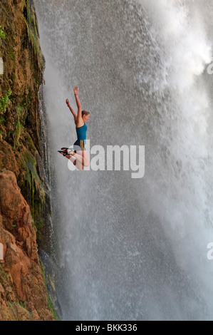 A travertine ledge below Havasu Falls where it plunges into a deep blue ...