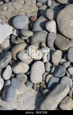 Pebbles on a shore of Georgian Bay covered with light snow. Wintertime ...