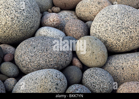 A photograph of smooth round granite rocks on a beach Stock Photo - Alamy