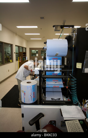 Inmate working at license plate manufacturing computer and printer at ...