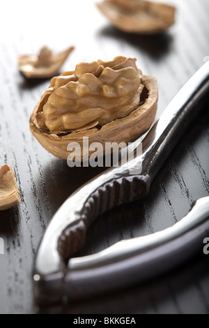 Selective focus shot of walnuts and nutcracker in green bowl Stock ...